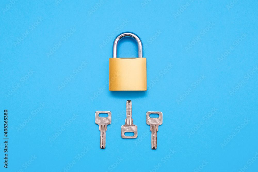 Closed padlock with three different keys on a blue background. Golden ...