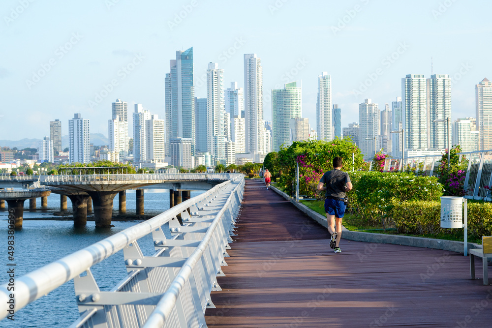 joggers on the pedestrian walkway of the marine viaduct in Panama City ...