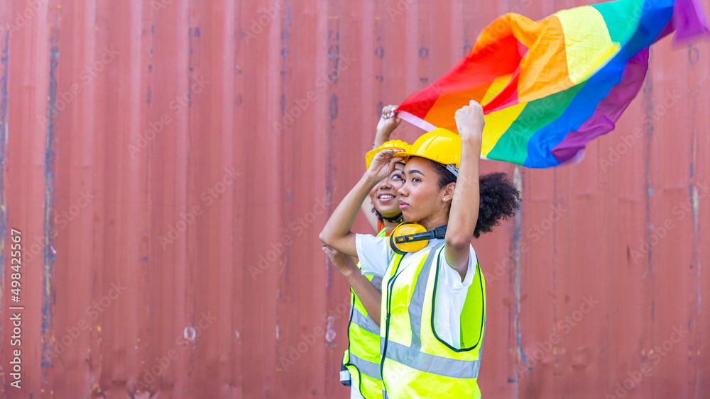 Young female African sisters in safety uniform and helmet show LGBT ...