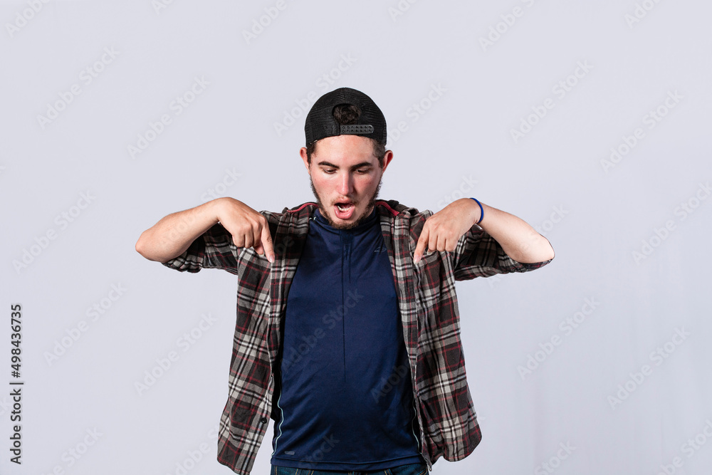 A man pointing down, surprised guy pointing his fingers down, amazed ...