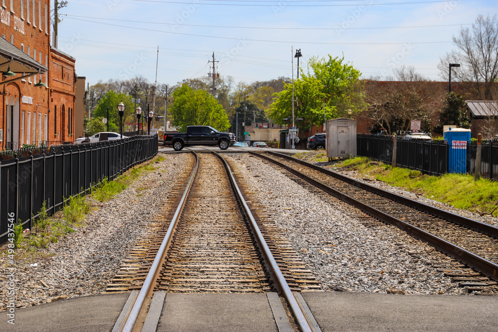 railroad tracks covered in gravel with lush green grass on the edges ...