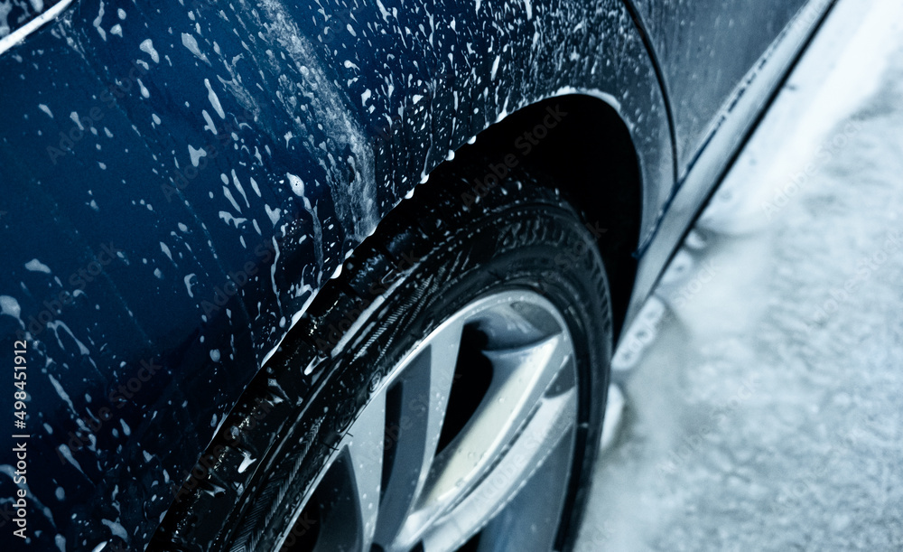Foto de Self-service car wash station. Active foam is cleaning a dirty ...