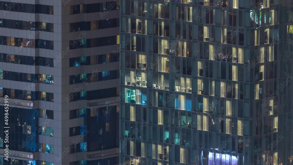 Windows in high-rise building exterior in the late evening with ...