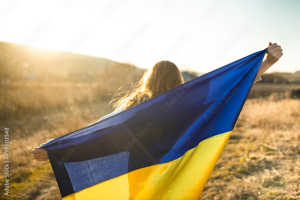 A woman with the flag of Ukraine in her hands. Ukrainian flag ...
