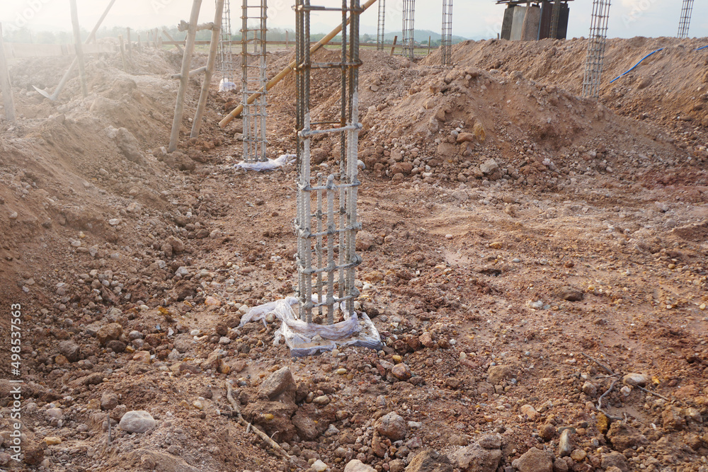 steel-reinforced concrete columns on the ground for the next stage of ...