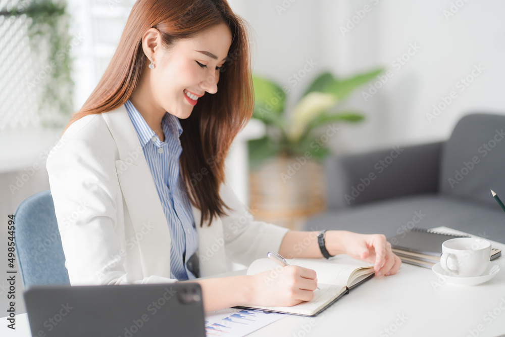 Portraits of beautiful smiling Asian women relax using laptop computer ...