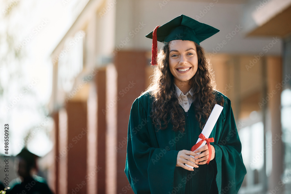 Happy female graduate student with diploma looking at camera. Stock ...