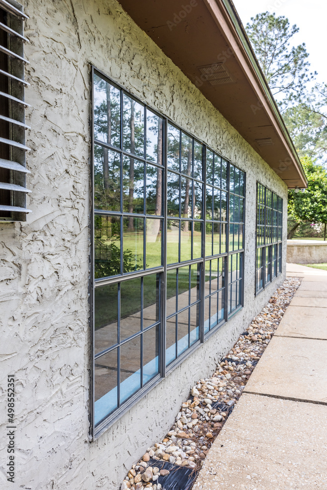 The side view of a brown 1970's ranch style spanish style villa stucco ...