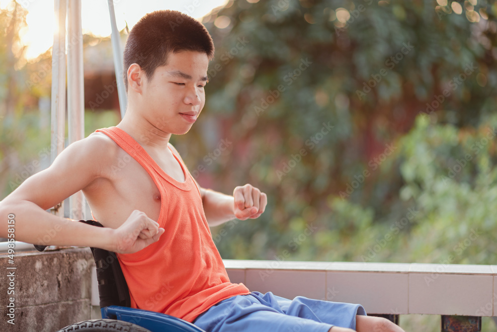 Young man with a disability by moving the head and limbs on a ...