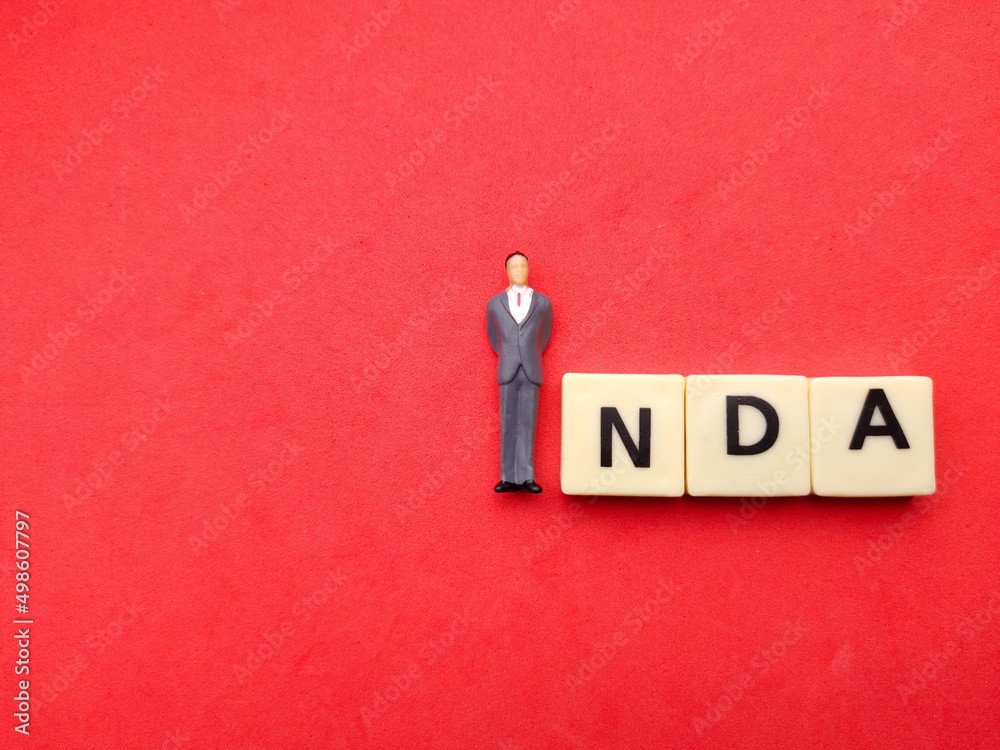 Miniature of a man with the word NDA on a red background with copy ...