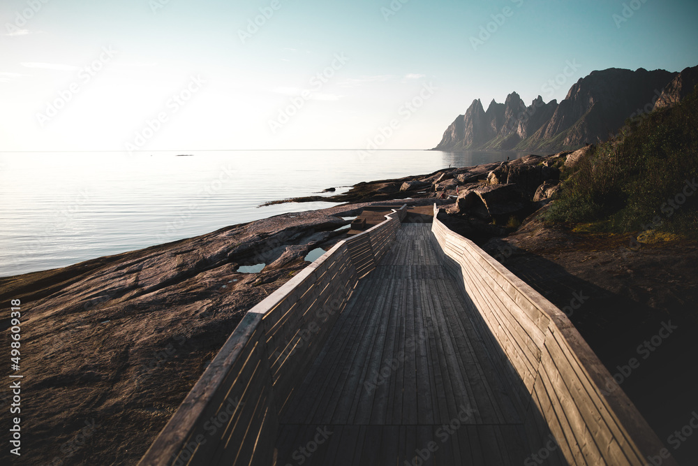 pathway through Senja, near the waters of Atlantic, over a background ...