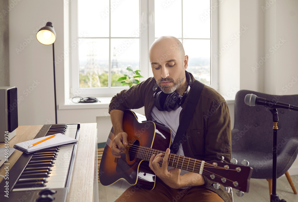 Talented man writing music. Pensive middle aged musician, songwriter ...