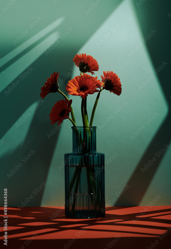 Vertical still life shot of fresh orange gerbera flowers in vintage ...