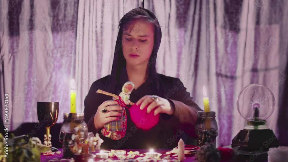 Dark magic voodoo witch performing ritual and casting spell piercing ...