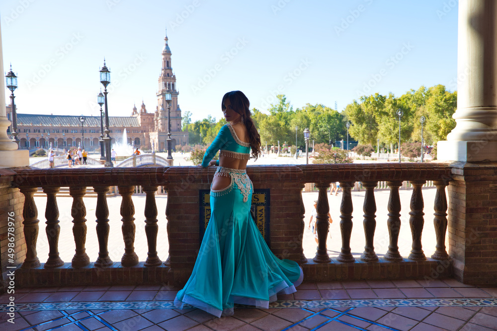 beautiful young belly dancer is posing for the camera in a photo shoot ...