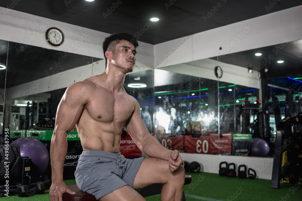 A shirtless asian man with a well built chest and a tight small waist ...