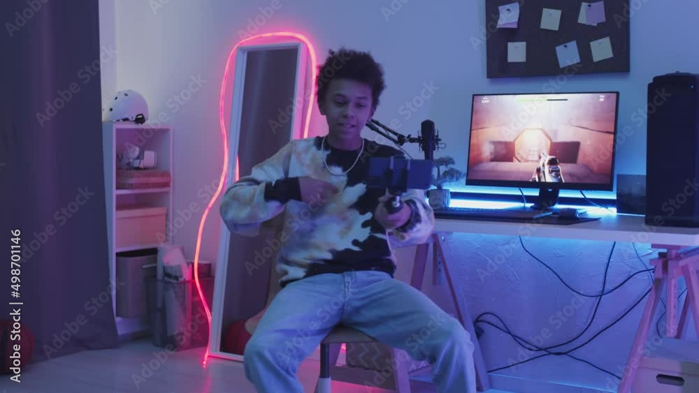 Slowmo of 14 year old Biracial online streamer recording video of ...