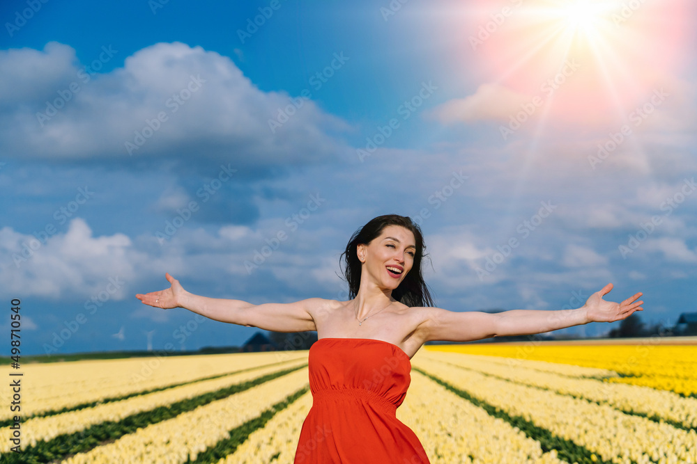 Beautiful Woman in summer dres standing in colorful tulip flower fields ...