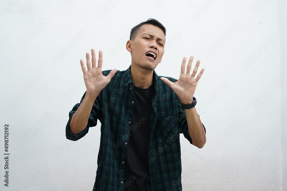 Asian young man wearing dark green casual shirt on white background ...