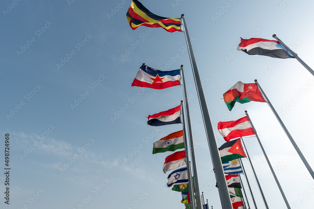 Flags of many countries on flagpoles, international cooperation concept ...