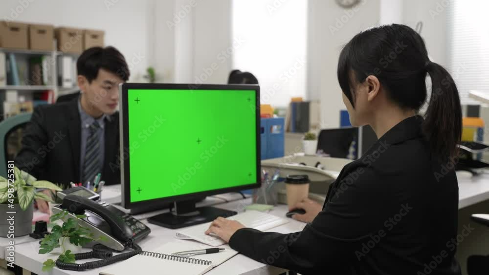 rear view of asian businesswoman wearing suit working on a desktop ...