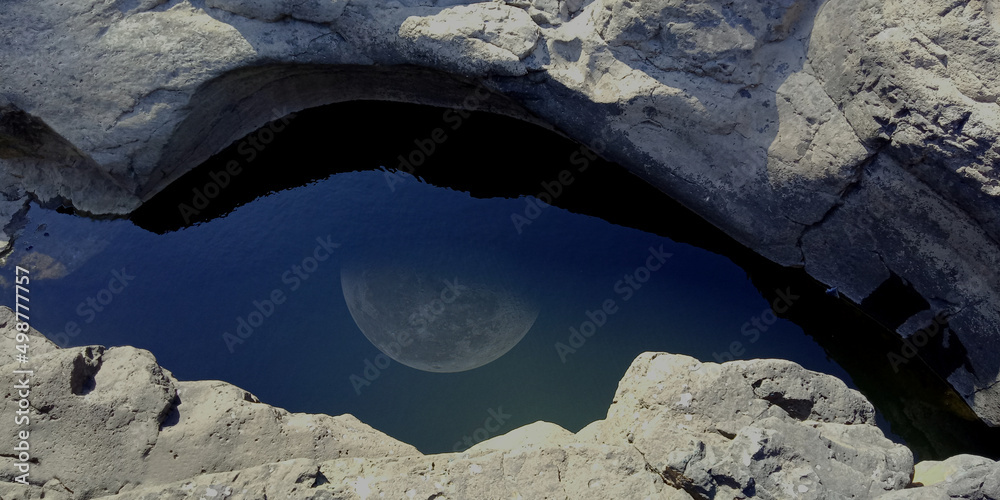 moon reflection on the water with eye shape rock Stock Photo | Adobe Stock