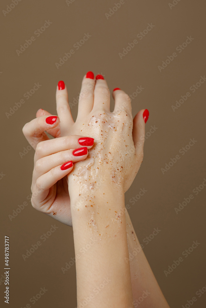 Cleansing scrub for hands. The girl applies scrub on the skin of her ...
