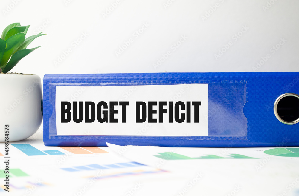 BUDGET DEFICIT text on folder with chart and calculator on white ...