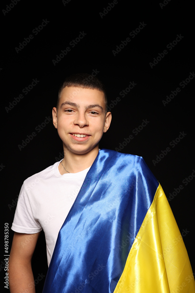 handsome Ukrainian man with Ukraine flag on black background. war in ...