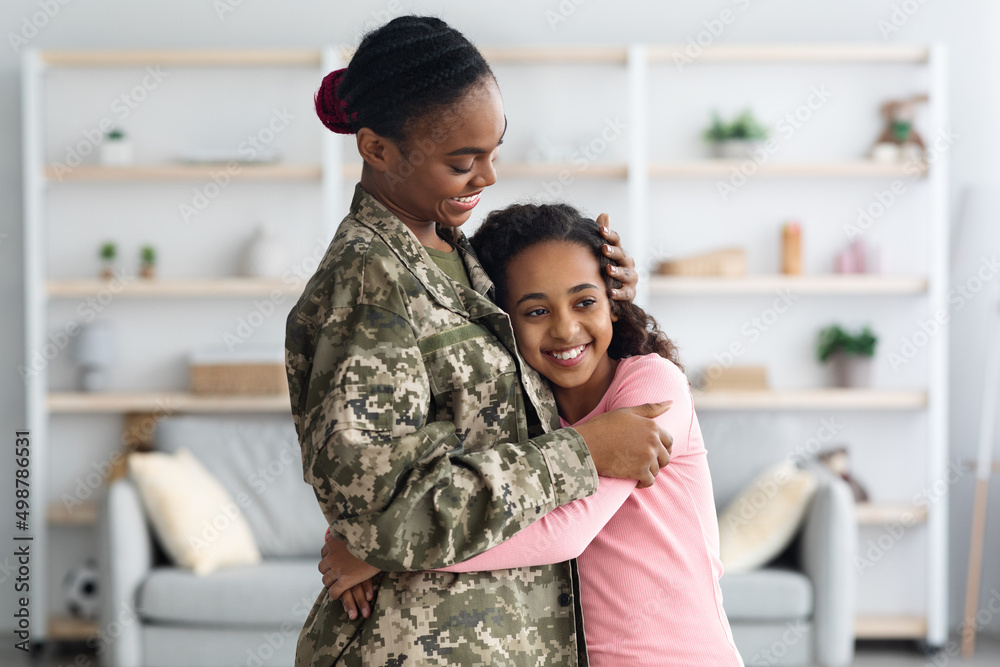 Adorable african american girl hugging her mother soldier Stock Photo ...