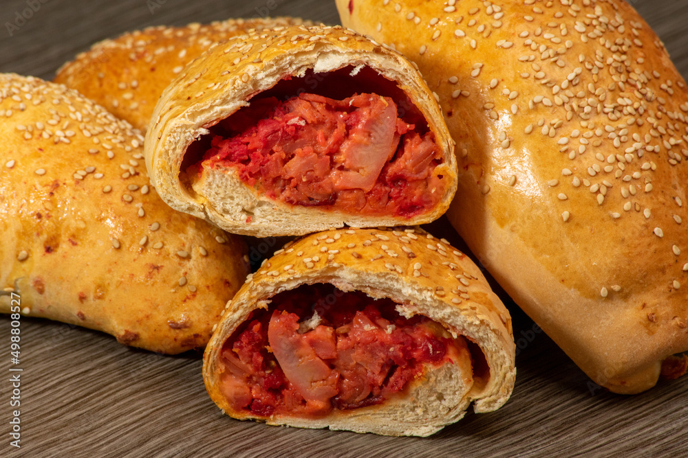 Baguette type bread known as a Spanish loaf stuffed with cold meats ...