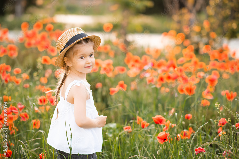 Smiling baby girl 3-4 year old wear straw hat and white rustic dress ...