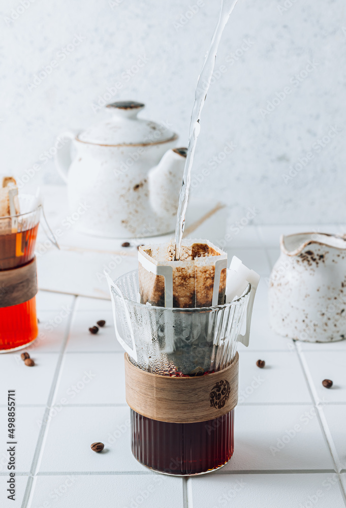 Ground drip coffee using paper type filter with coffee beans on white ...