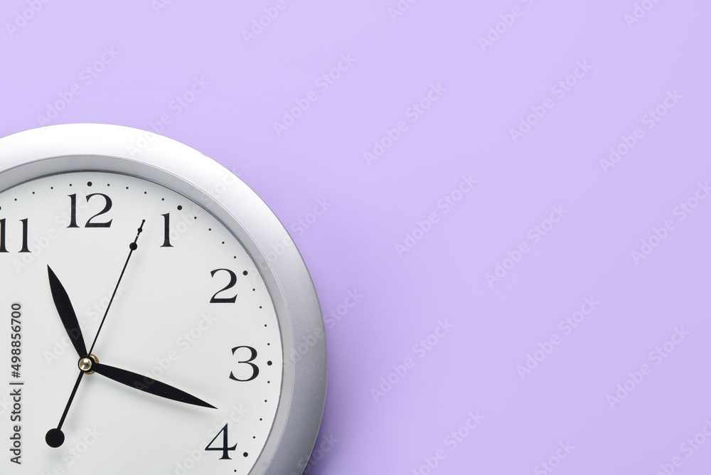 New modern clock on purple background, closeup Stock Photo | Adobe Stock