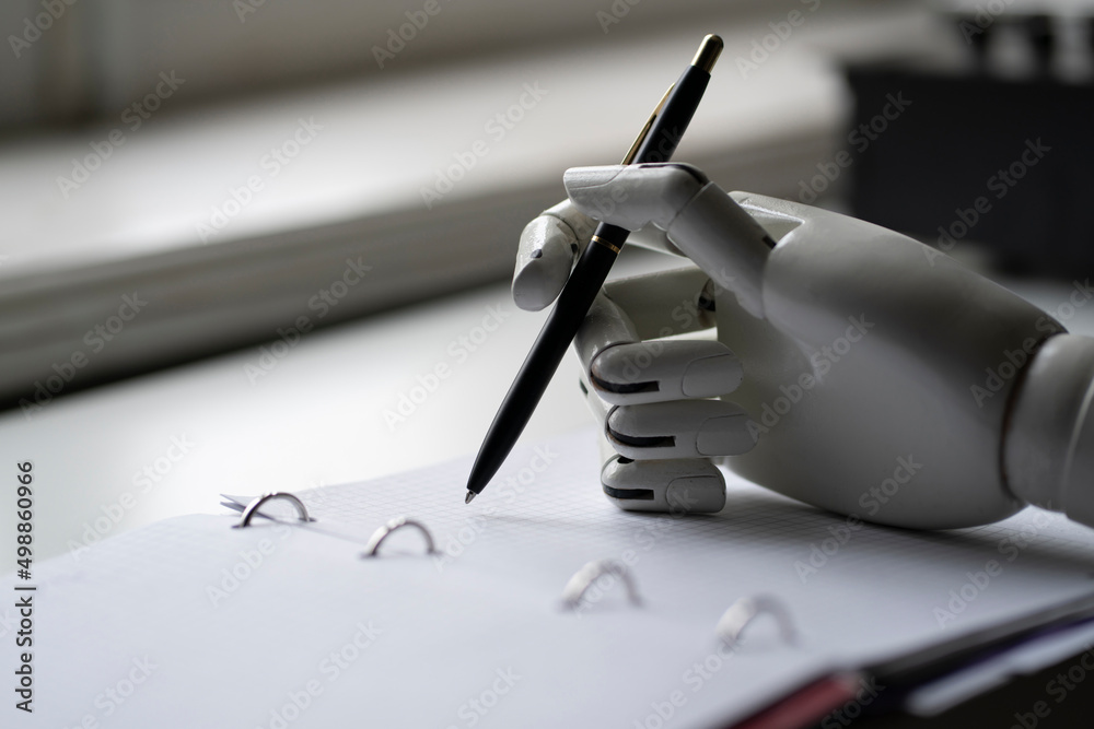 artificial robotic arm write down some notes with pen Stock Photo ...