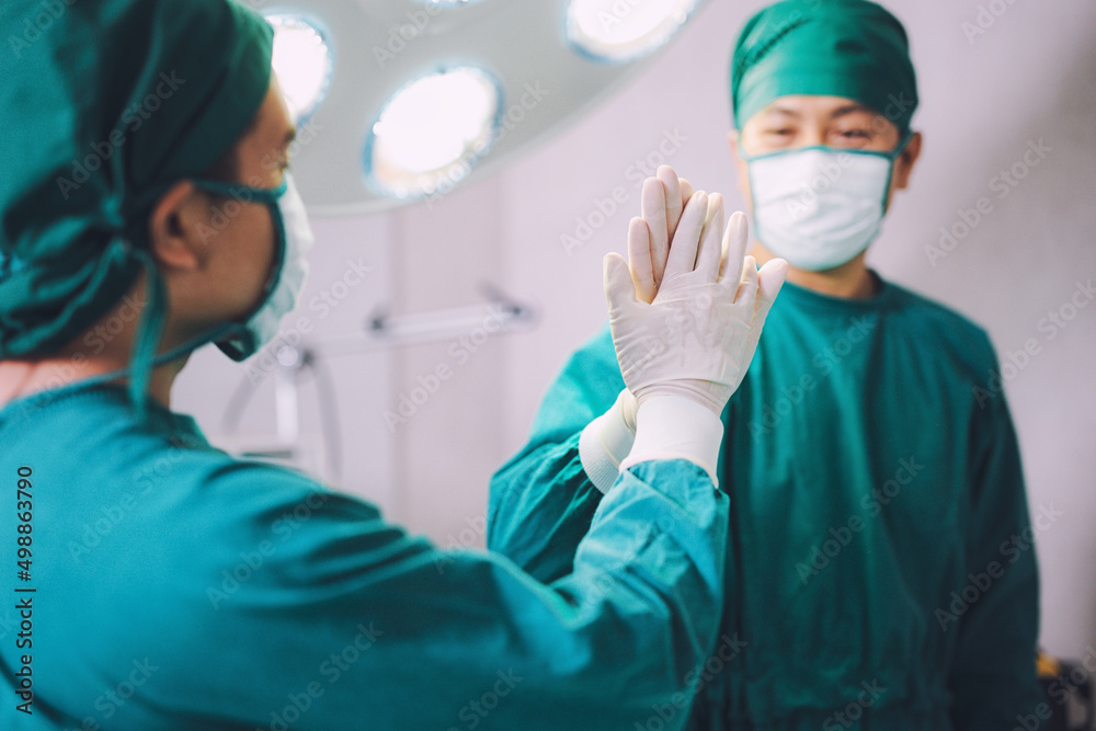 The team of surgeons hand tags to show their cooperation to achieve the ...