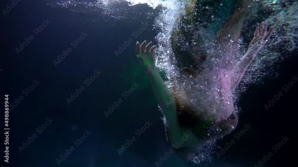 mysterious underwater world, mermaid is diving in dark depth of sea or ...