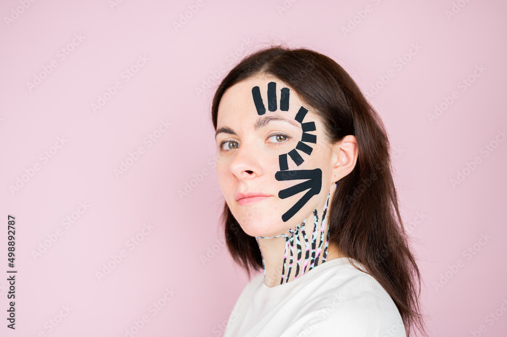 Young beautiful woman with aesthetic taping procedure, pink background ...