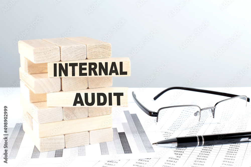 INTERNAL AUDIT is written on wooden blocks on a chart background Stock ...