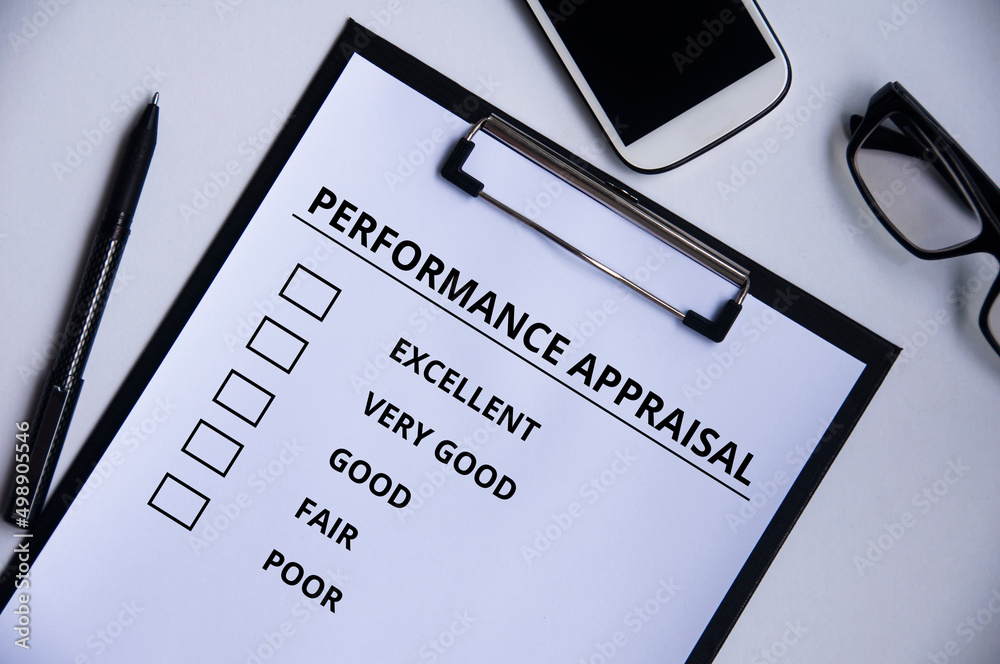 Top view of performance Appraisal checklist on clip board with pen ...