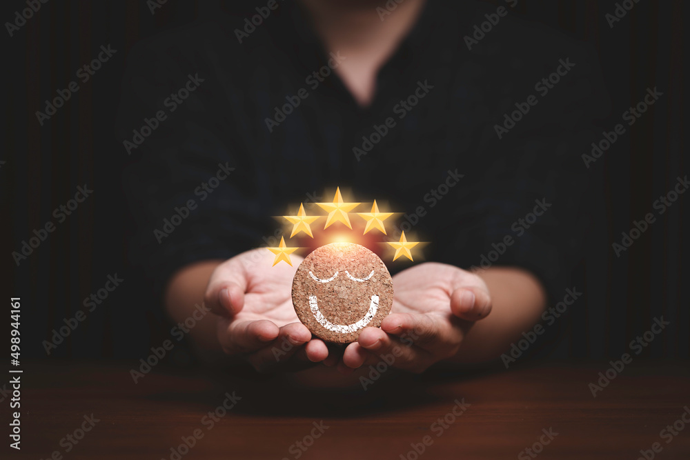 Businessman holding and giving smile face with five golden stars which ...