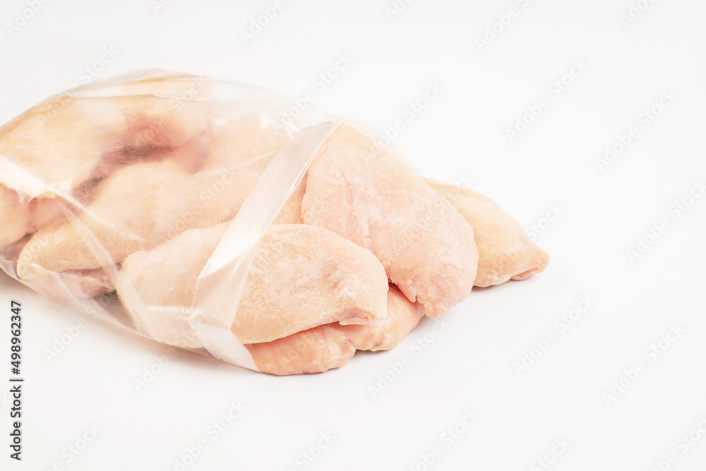 Frozen pieces of chicken fillet on an isolated white background.Chicken ...
