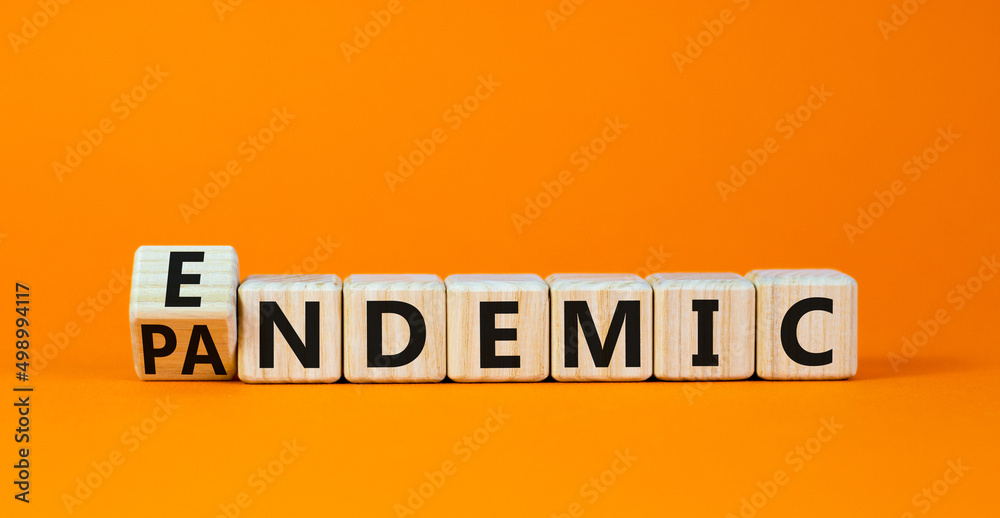 Covid-19 pandemic or endemic symbol. Turned wooden cubes and changed ...