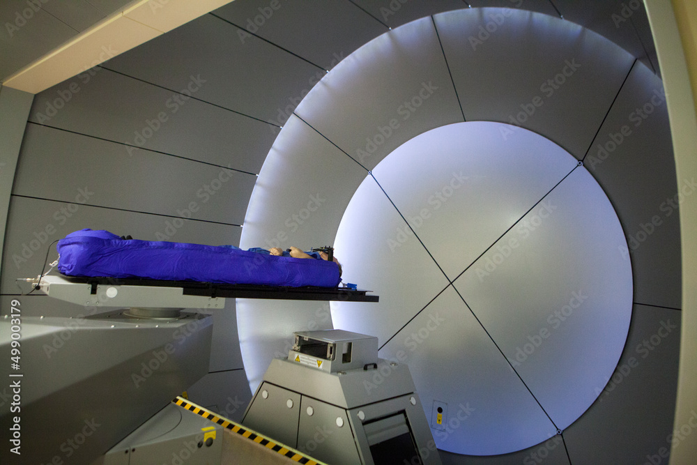 Proton therapy irradiates cancer cells with a beam of protons. Stock ...
