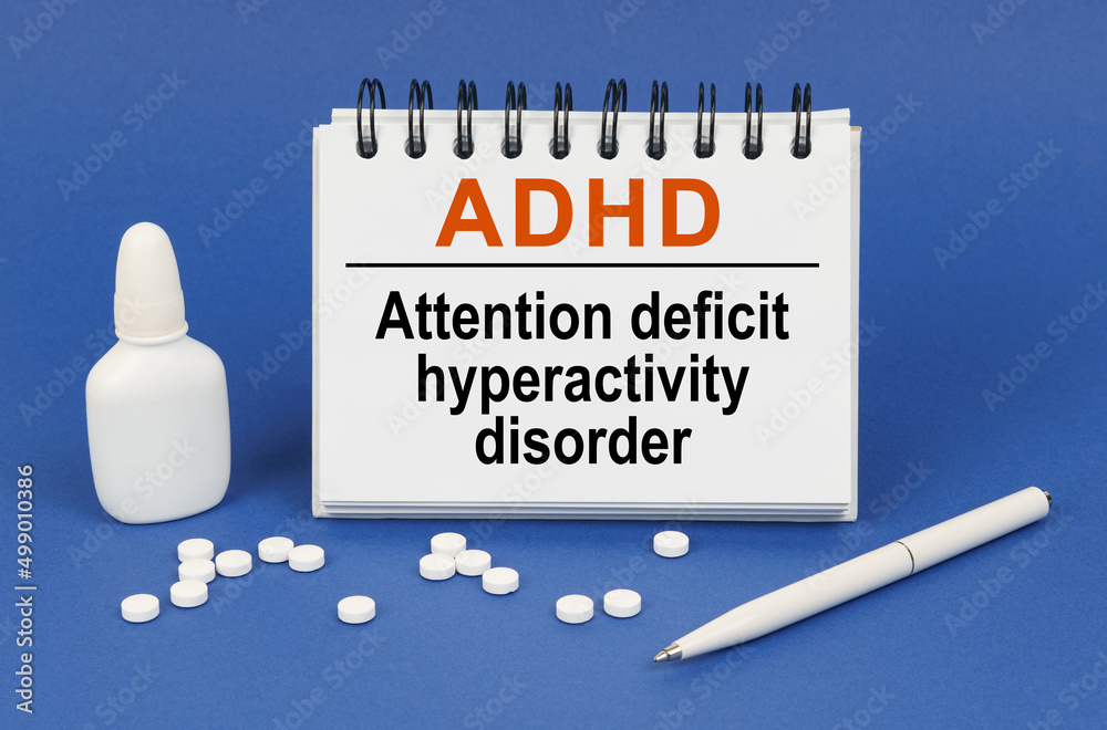 On a blue background, a pen, tablets and a notepad with the inscription ...