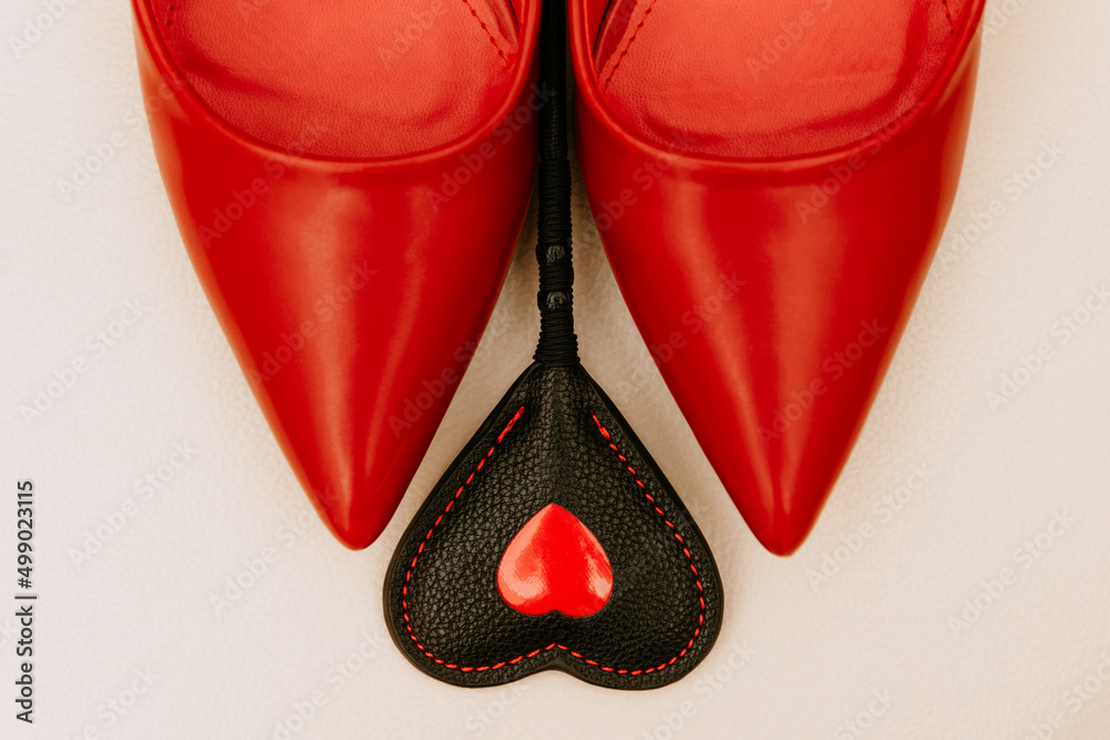 Red leather high heel shoes and bdsm crop. Strict woman's domination ...