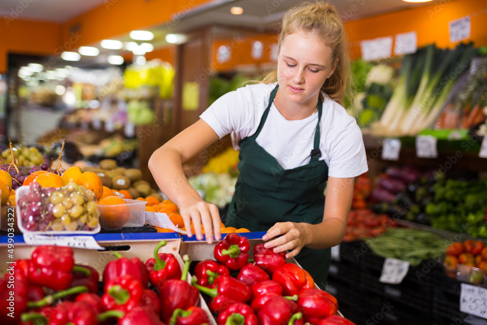 Portrait of teenage girl working in supermarket as job experience ...