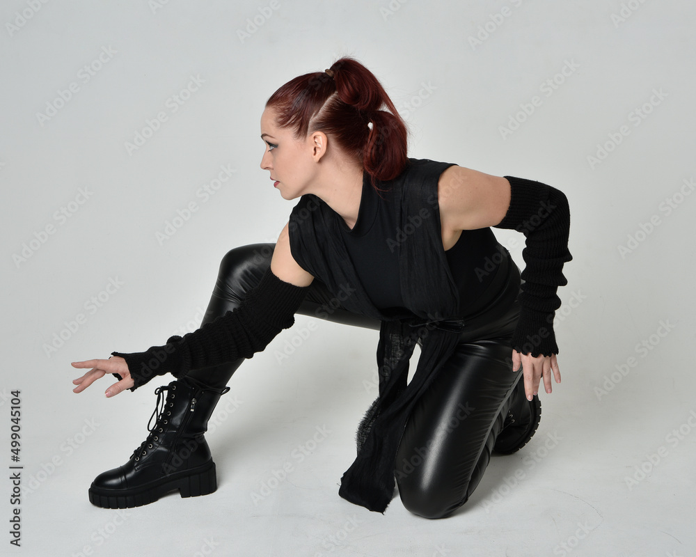 Full length portrait of pretty redhead female model wearing black ...