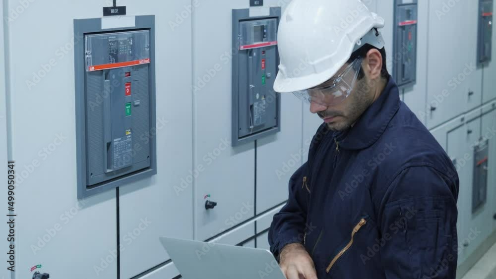 Electrical engineer using digital tablet inspect and program for ...