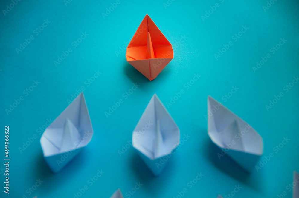 Leadership Concept - Orange color paper ship origami leading the rest ...